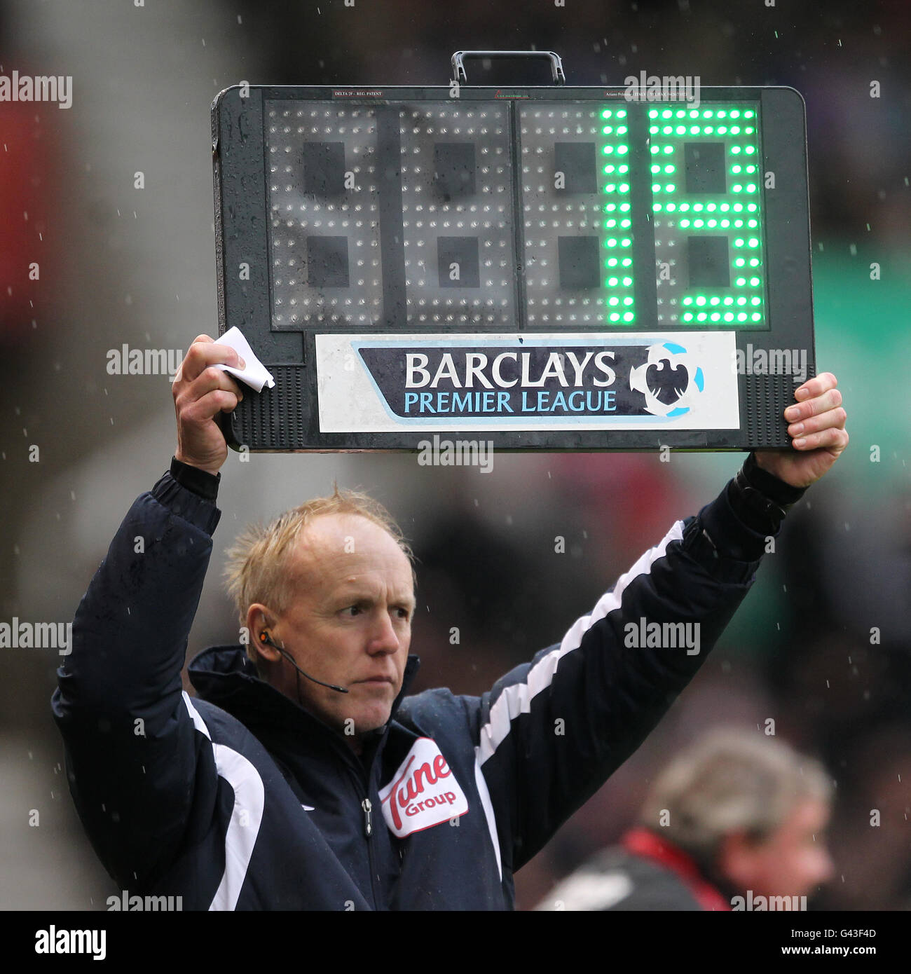 The fourth official holds up the electronic board for substitution hi-res stock photography and ...