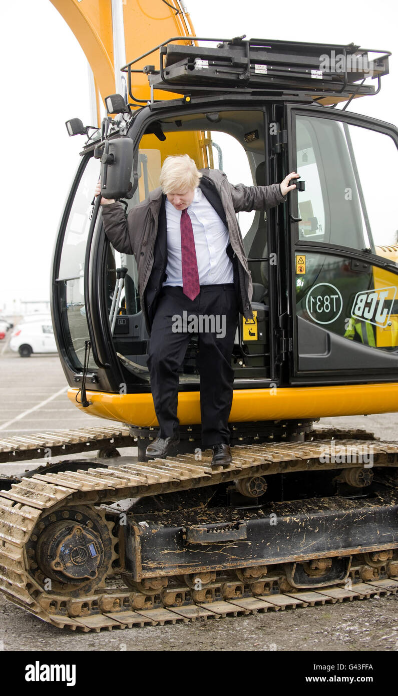 London Mayor Boris Johnson climbs from a digger marking the start of ...