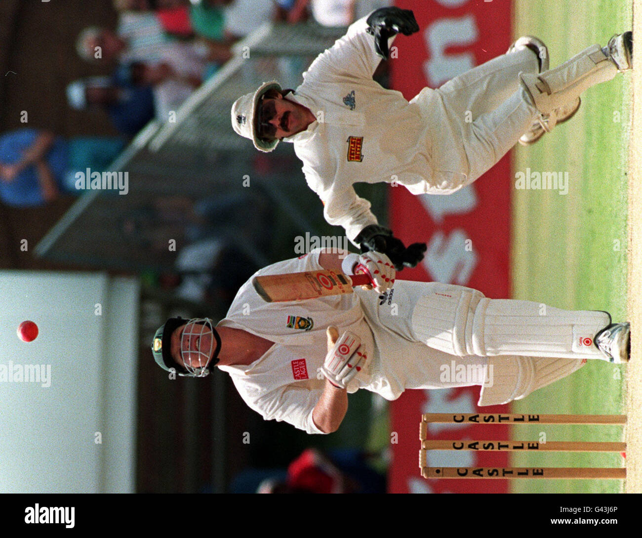 England wicket keeper Jack Russell (right) runs round South Africa's ...