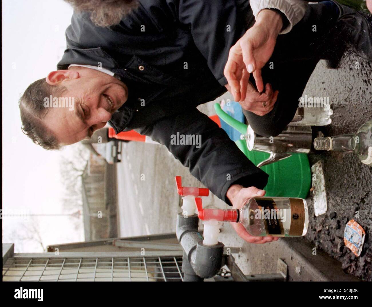 SCOTCH & WATER: Bernard Boyle fills up a whisky bottle at a water ...