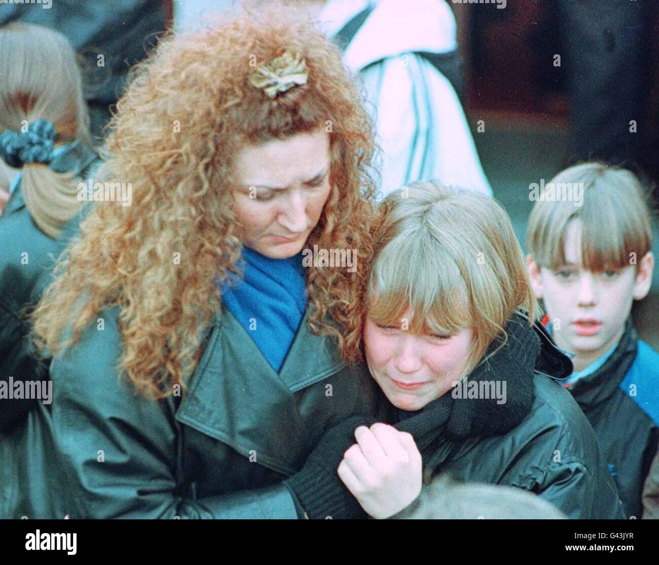 One of Tracey Patterson's school mates is comforted at her funeral in ...