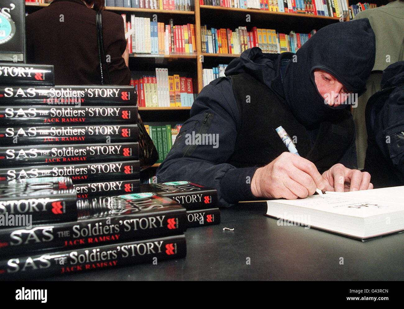 'Mac', a former member of the SAS, sits with two of his colleagues as ...