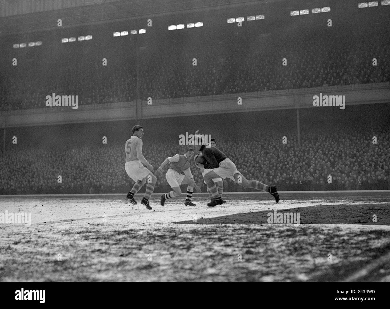 Bert Trautmann, Manchester City goalkeeper, snatches the ball before it ...