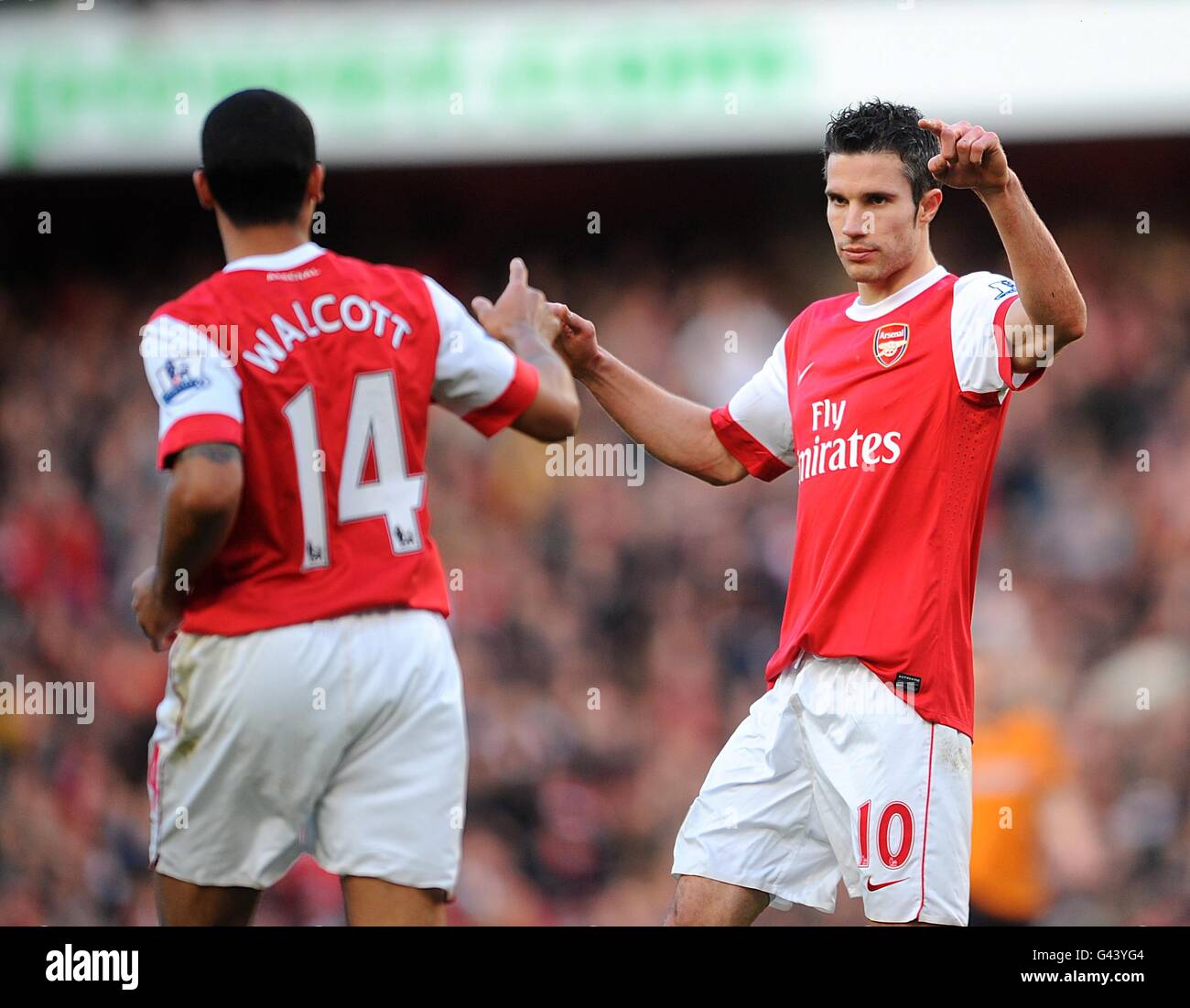 Arsenal's Robin van Persie (right) celebrates scoring his team's second ...