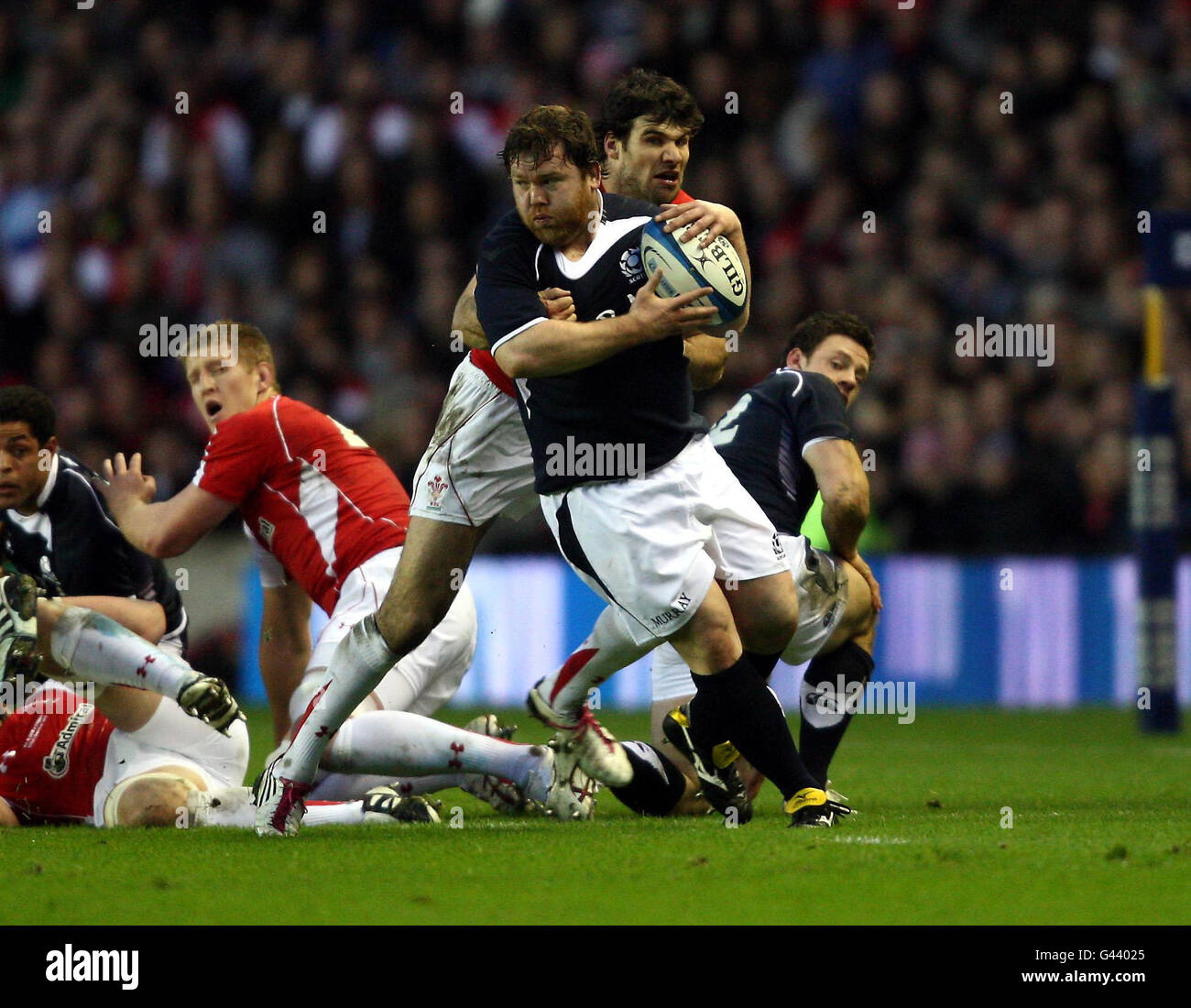 Scotland's Allan Jacobsen is tackled by Wales' Mike Phillips during the ...