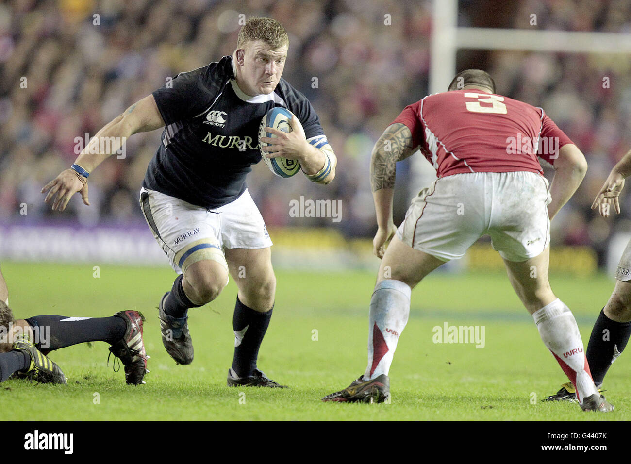 Scotland's Moray Low (L) challenged by Wales' Craig Mitchell (R) during ...