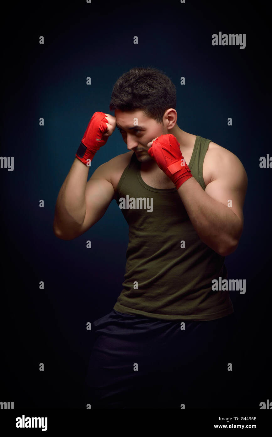 Portrait of a male boxer. Young sporty man on a dark background Stock ...