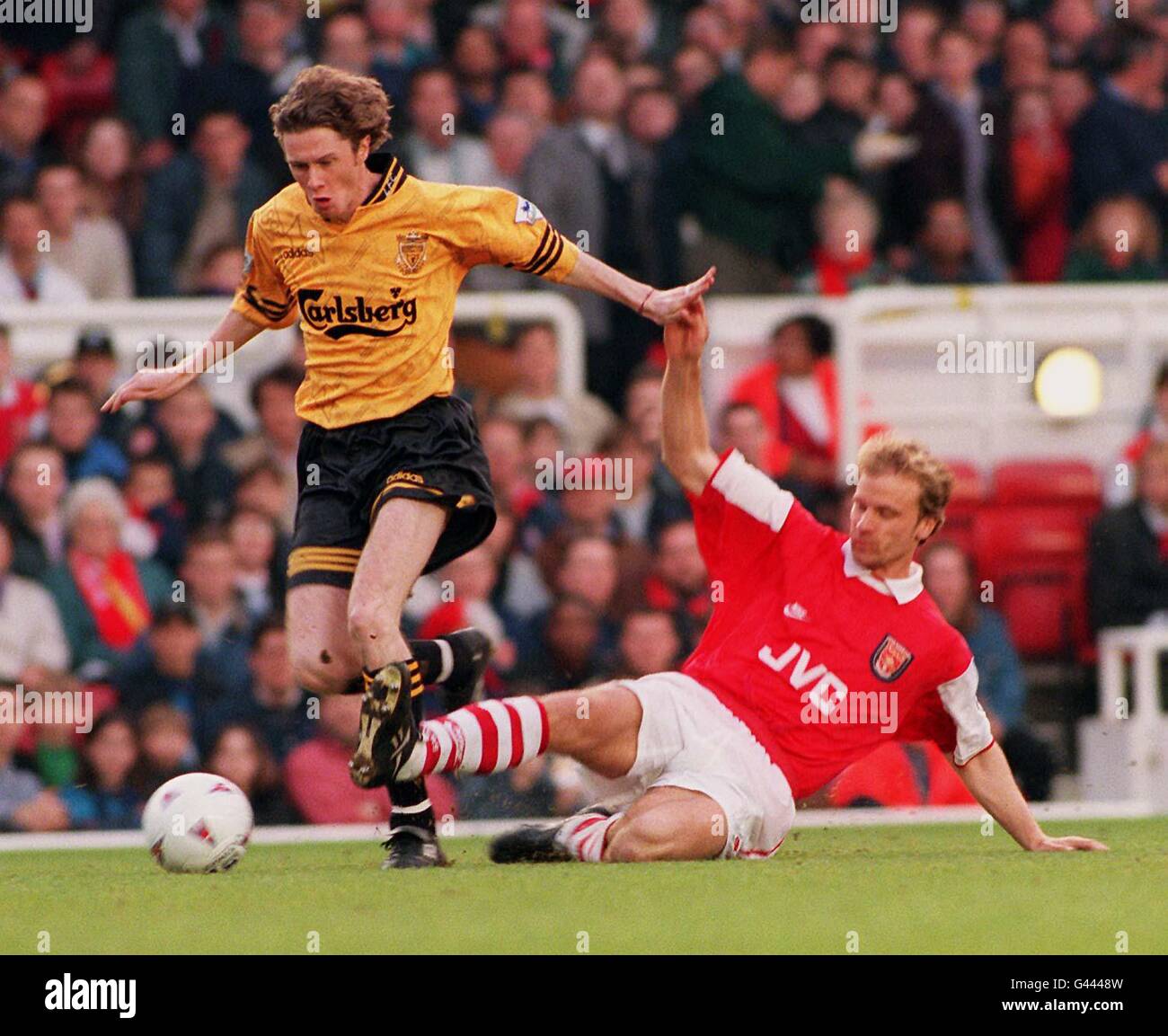 Liverpool winger Steve McManaman races past the sliding tackle of ...