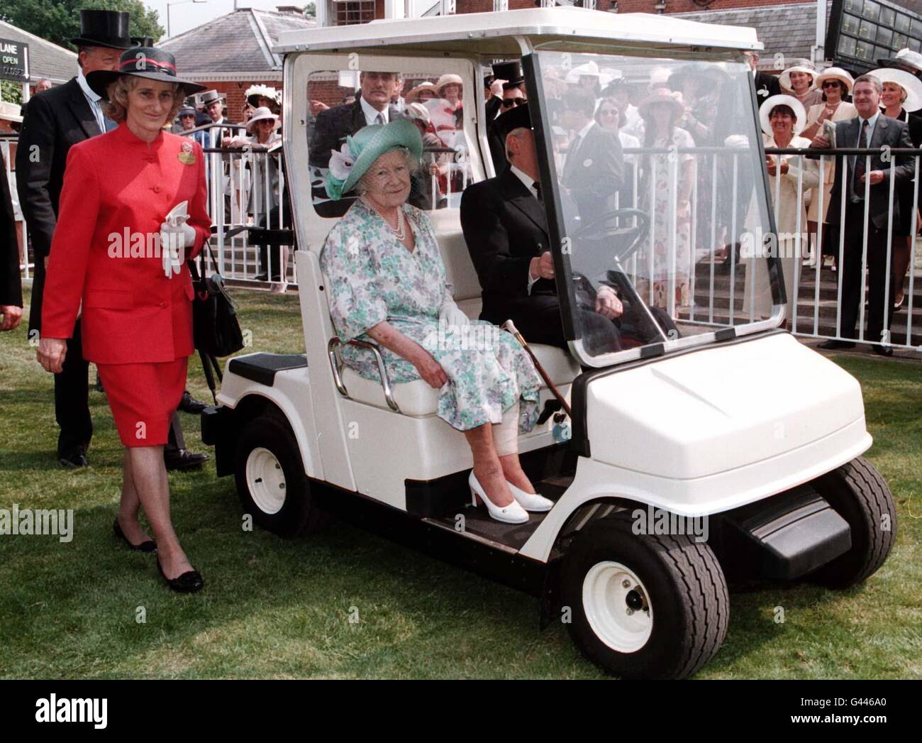 Queen Elizabeth the Queen Mother drives in her chauffeur driven buggy ...