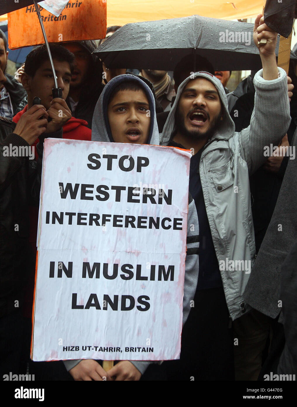 Anti-Gaddafi protesters hold up banners outside the Libyan Embassy in ...