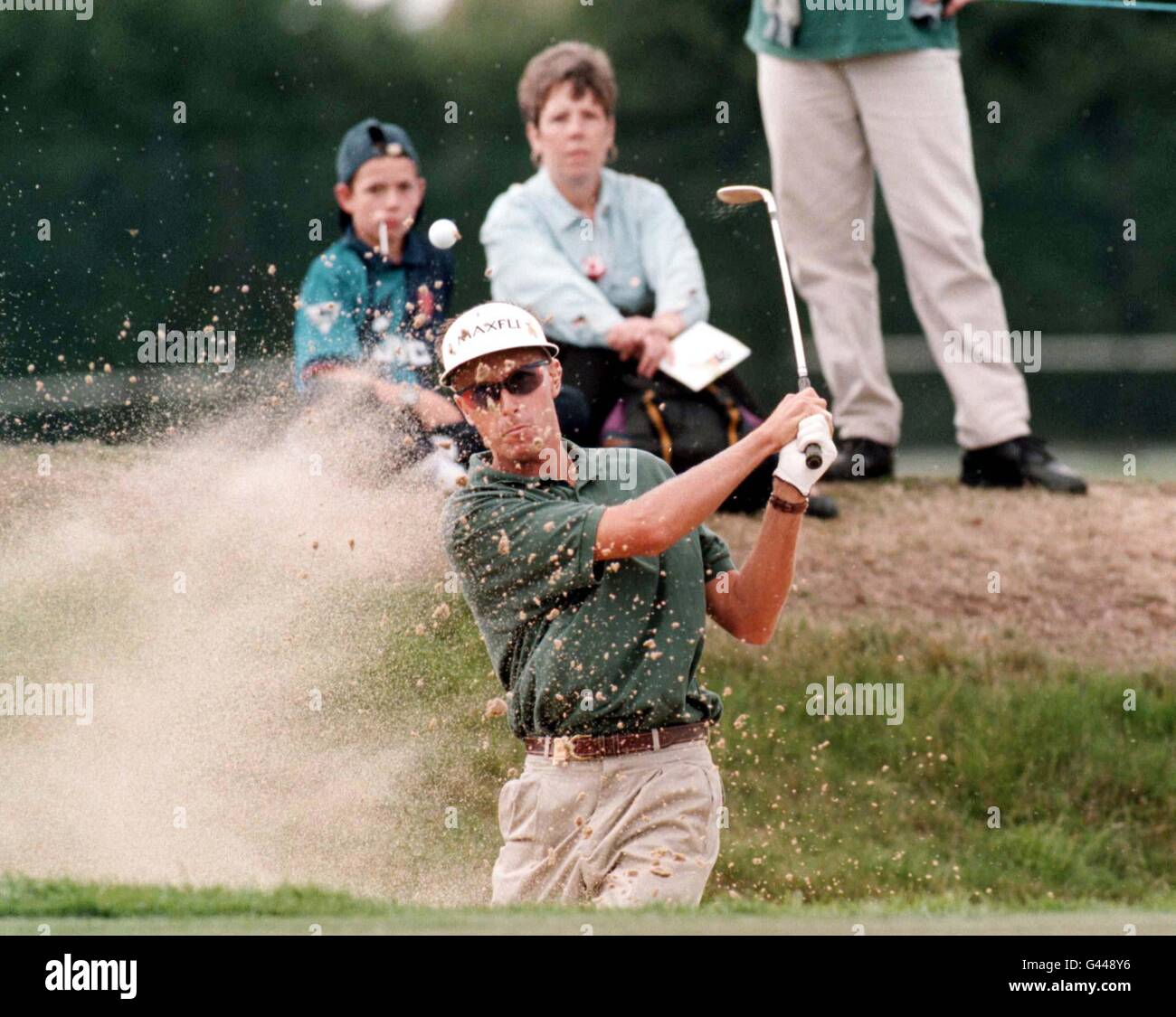 Robert Allenby of Australia chips a shot out of a bunker on the 16th ...