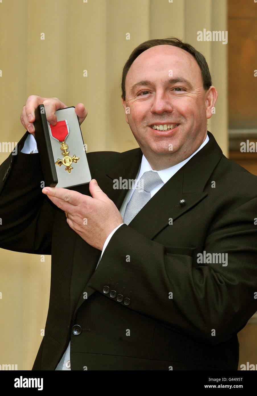 Keith Dunn holds his OBE after it was presented to him by Queen ...