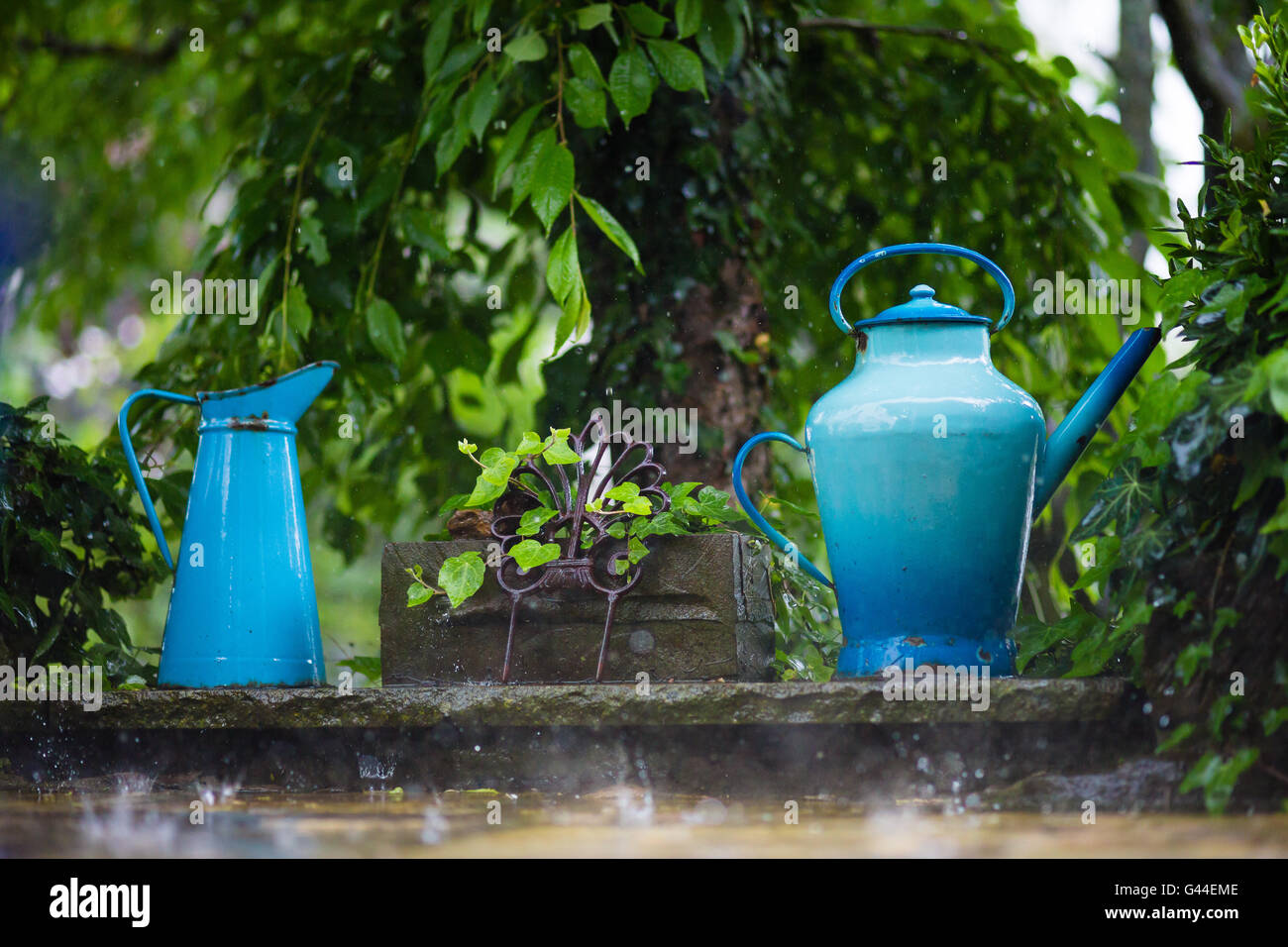 Rain drops with watering can Stock Photo - Alamy