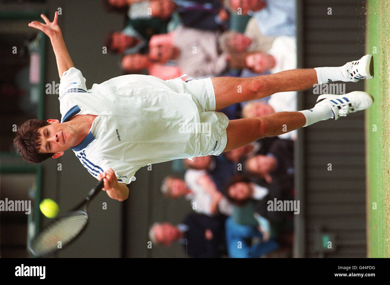 Britain's Tim Henman flies through the air to receive a ball from ...