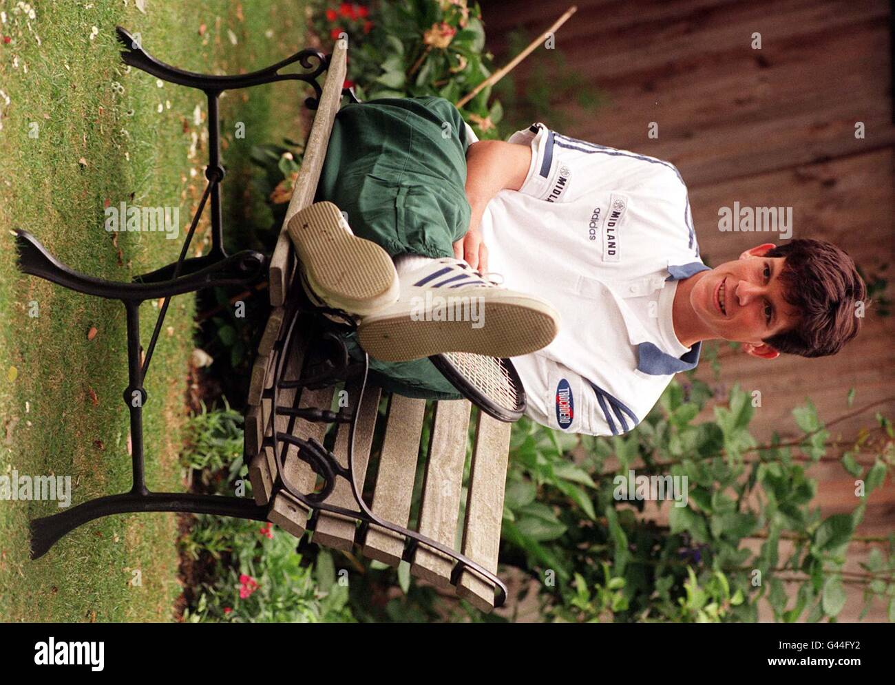 Britain's Wimbledon tennis hopeful Tim Henman relaxes on a bench today ...