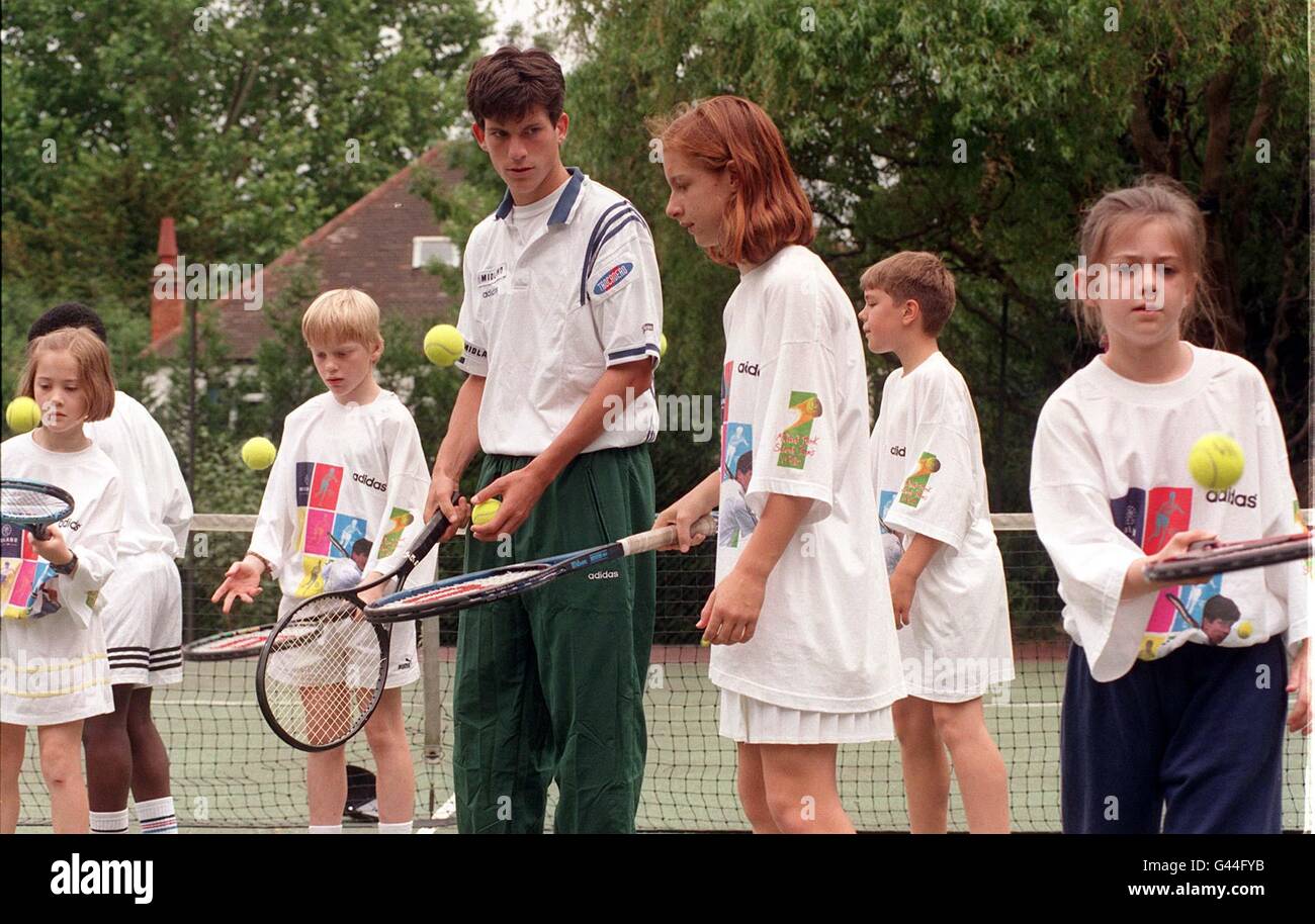 Britain's Wimbledon tennis hopeful Tim Henman coaches a group of ...