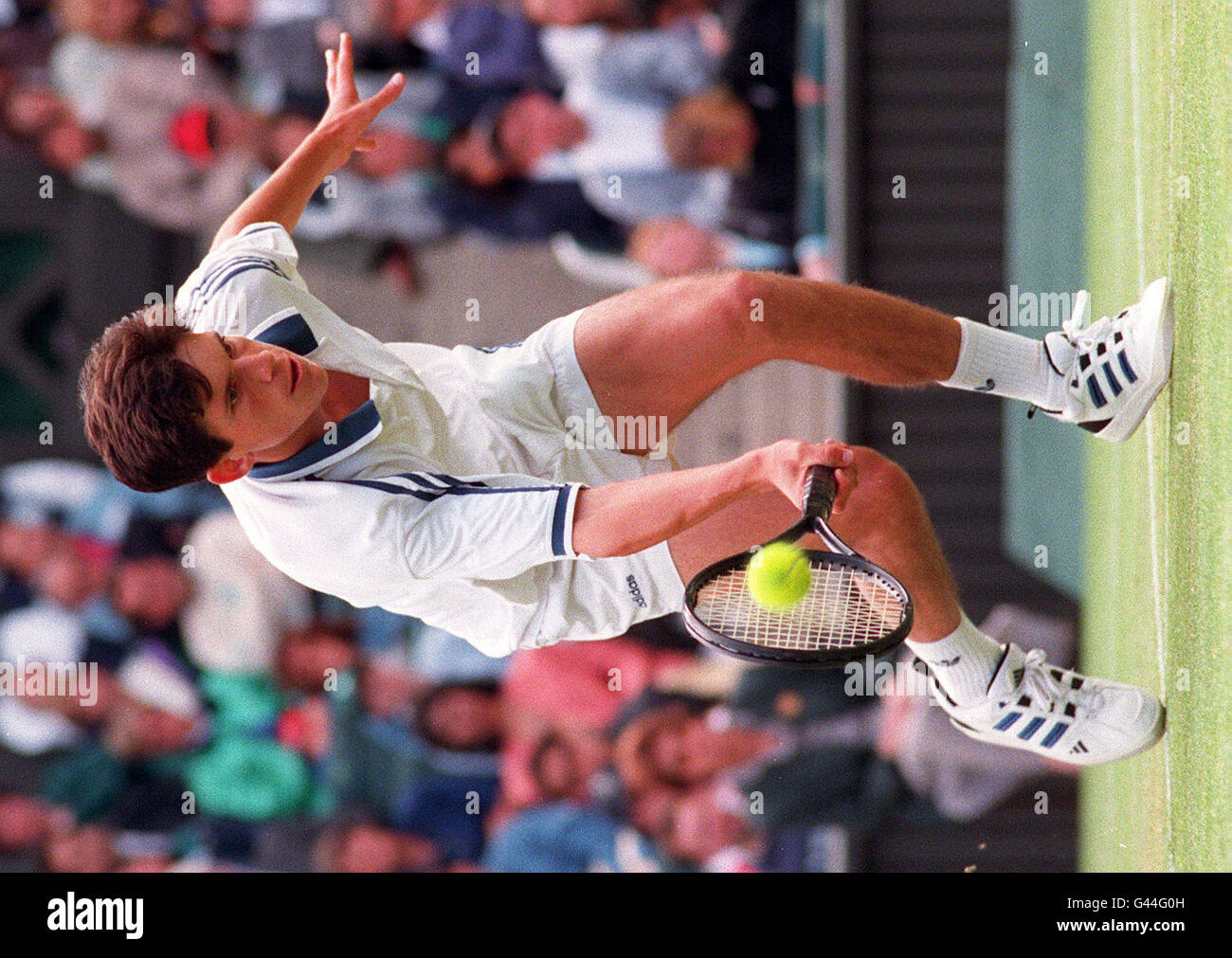 Britain's Tim Henman stoops for a low ball during his Centre Court ...