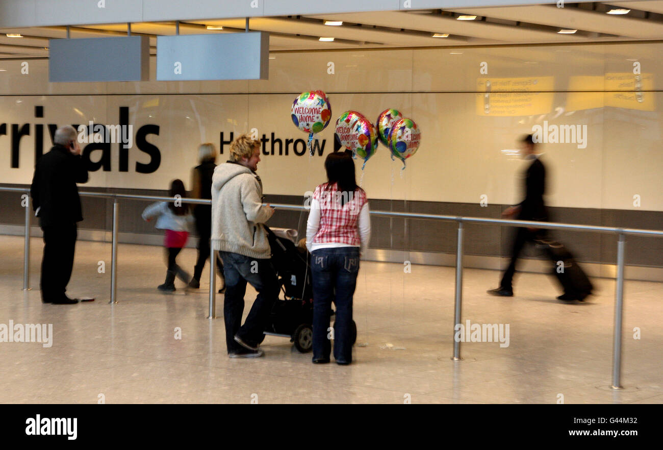 A family bring welcome home balloons to meet their loved ones at ...