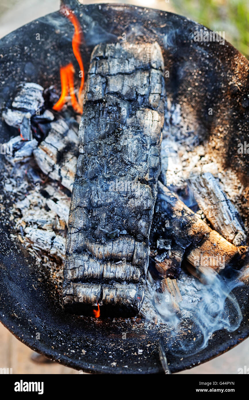 Wood burning with flames, ash and smoke in a barbecue Stock Photo - Alamy