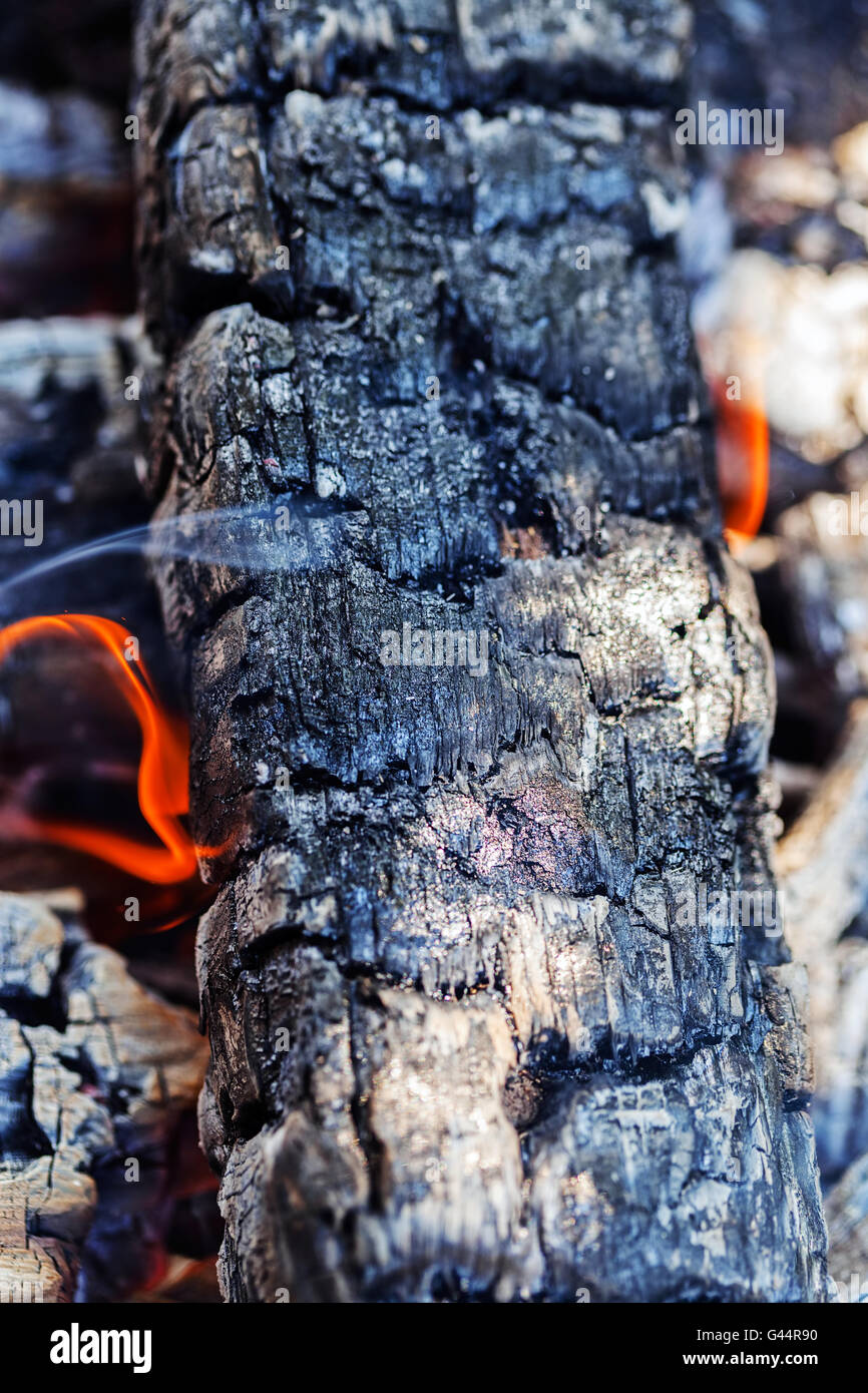 Wood burning with flames, ash and smoke in a barbecue Stock Photo - Alamy
