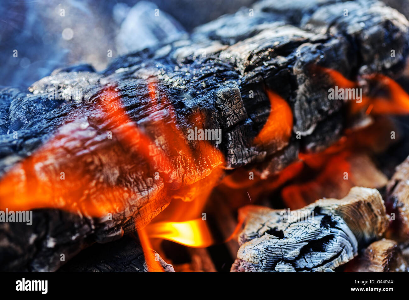 Wood burning with flames, ash and smoke in a barbecue Stock Photo - Alamy