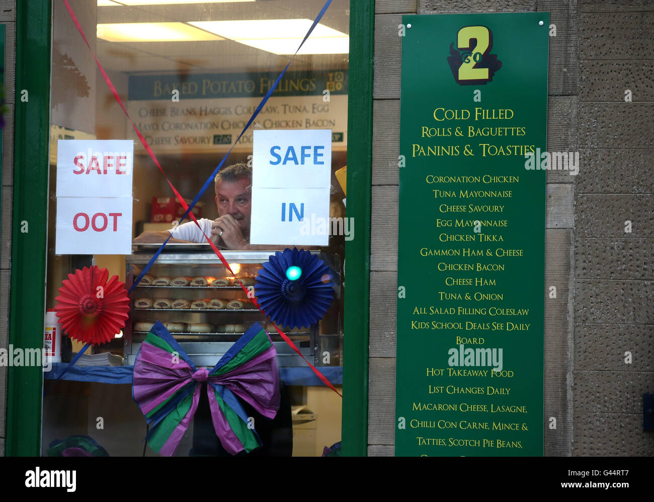 A shopkeeper looks out from his window during the Selkirk Common Riding ...