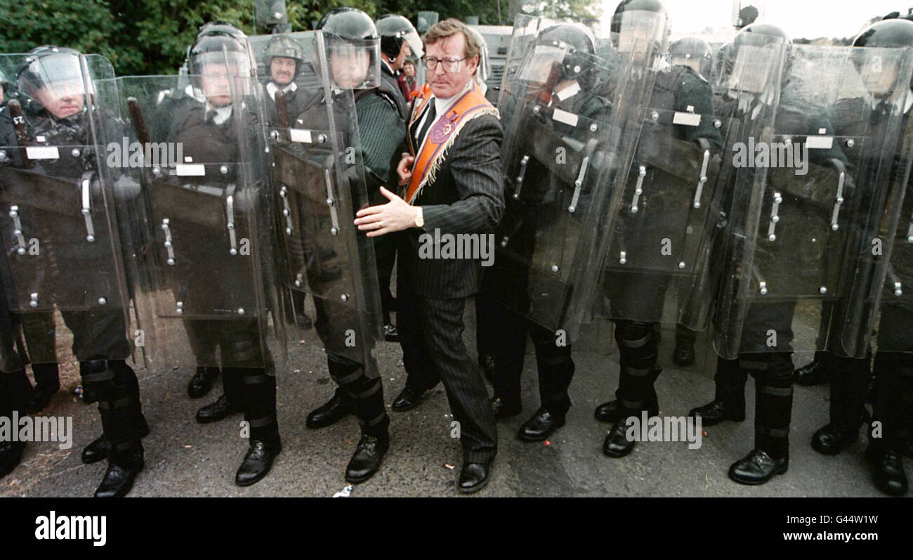 Ulster Unionist MP David Trimble squeezes through the RUC line after ...