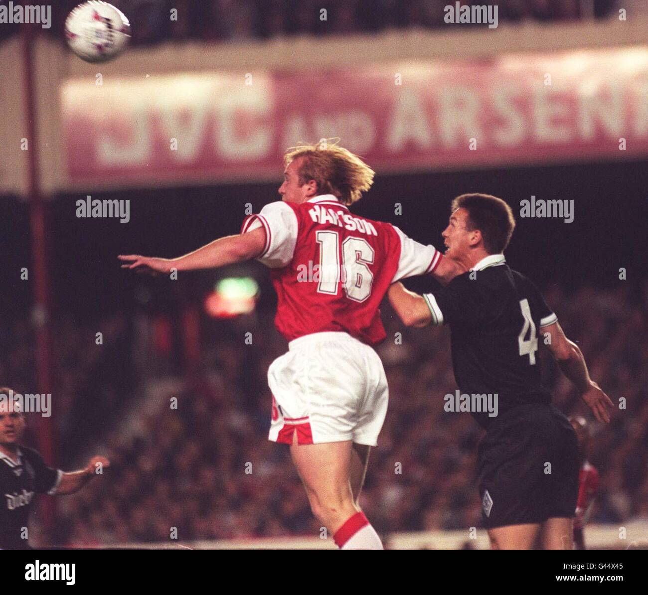 Arsenal's John Hartson heads from Borussia's Patrik Andersson during ...