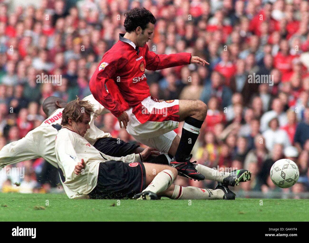 Ryan Giggs of Manchester United evades a double challenge by Liverpool ...