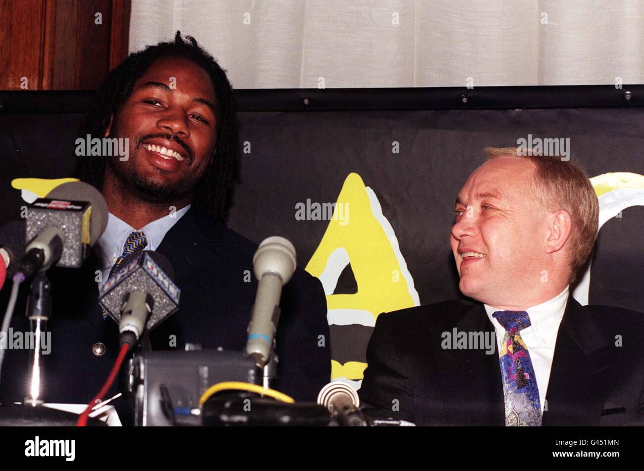 Britain's Lennox Lewis laughs with his manager Frank Maloney (r) during ...