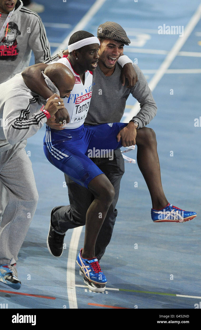France's Teddy Tamgho is picked up by team mates after he broke the ...