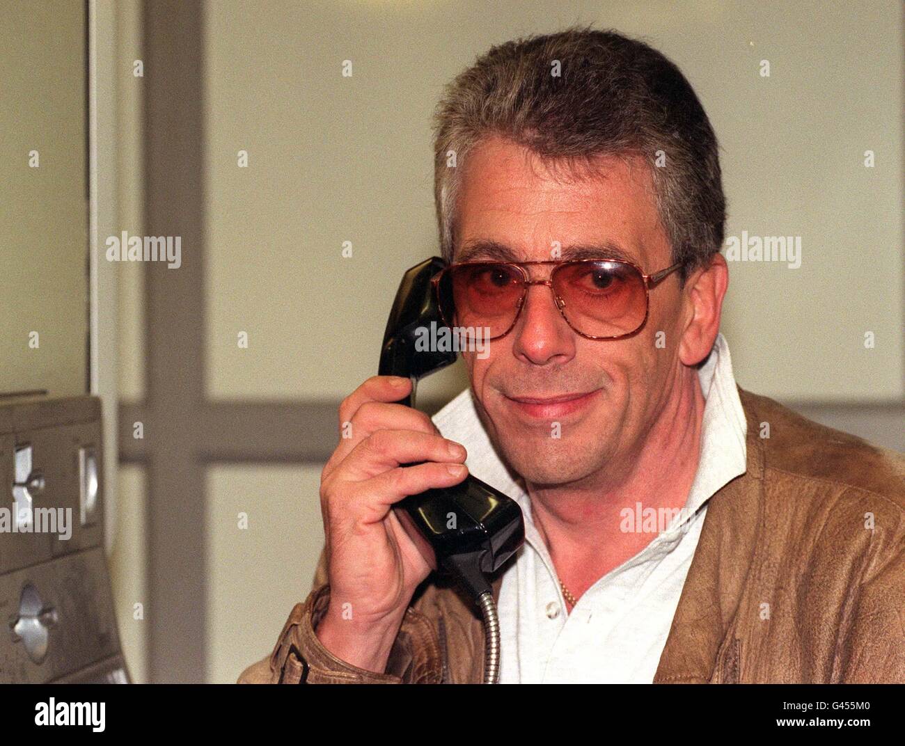 The Hon Peter Curzon, eldest son of Lord Scarsdale, on the telephone at ...
