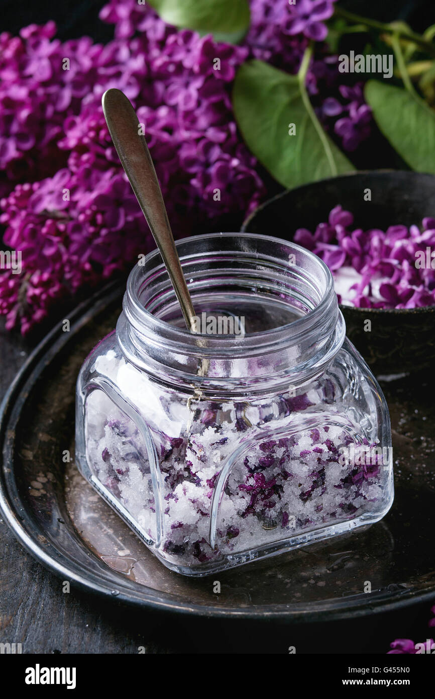 Square glass jar of lilac flowers in sugar, silver spoon and lilac ...