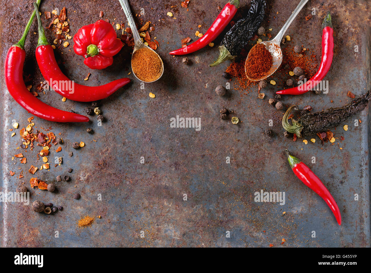 Spicy background with assortment of different hot chili and allspice ...