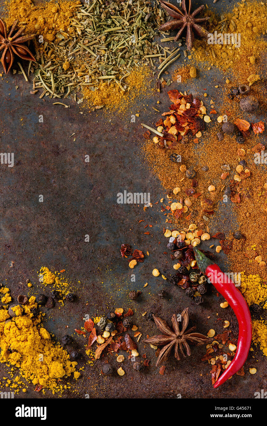 Spicy background with assortment of different hot chili and allspice ...