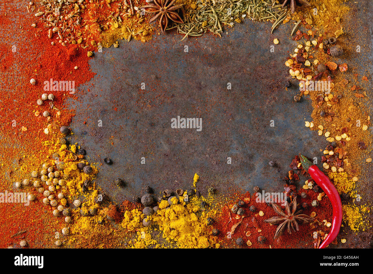 Spicy background with assortment of different hot chili and allspice ...