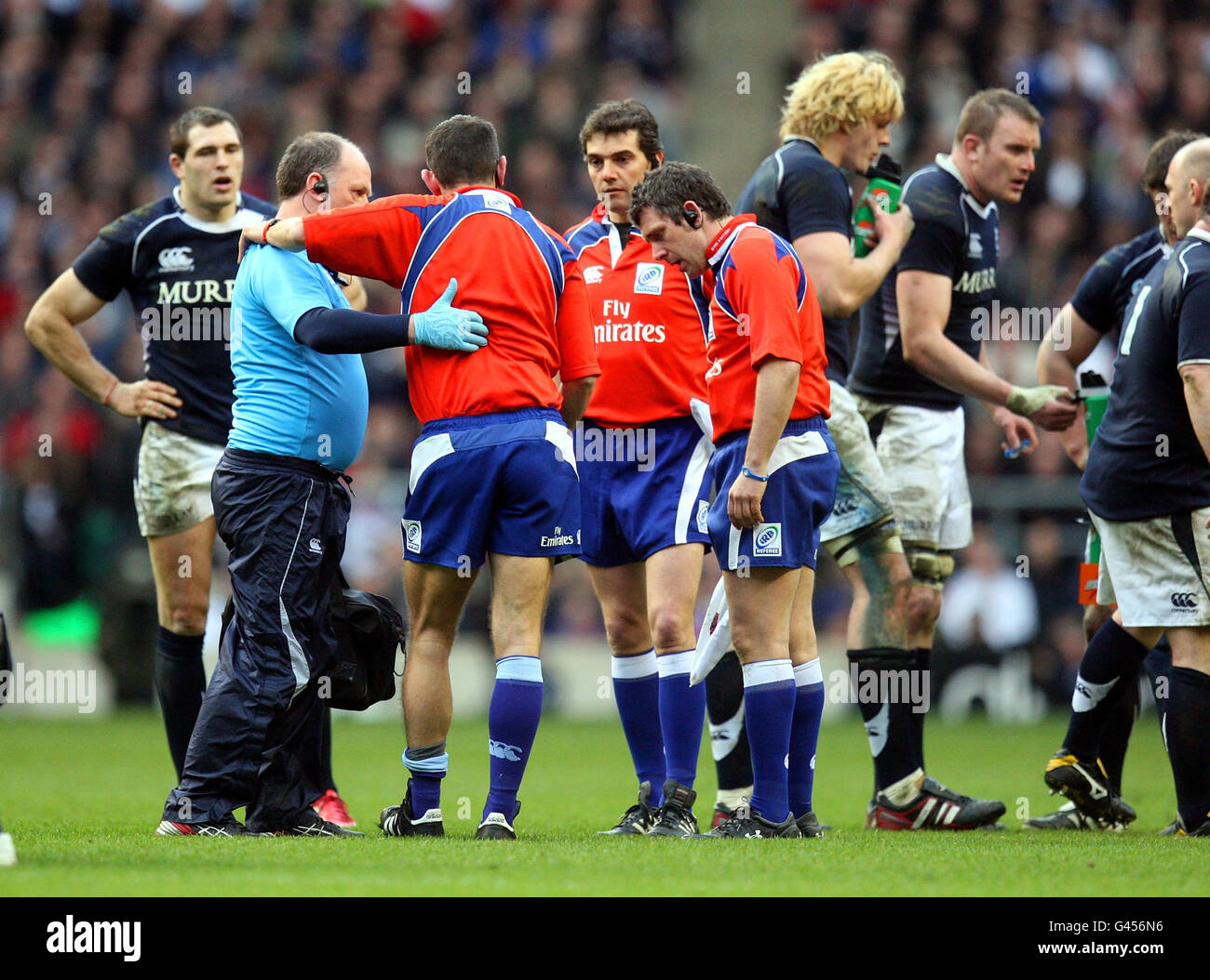 French referee Romain Poite (third left, facing away) is given medical ...