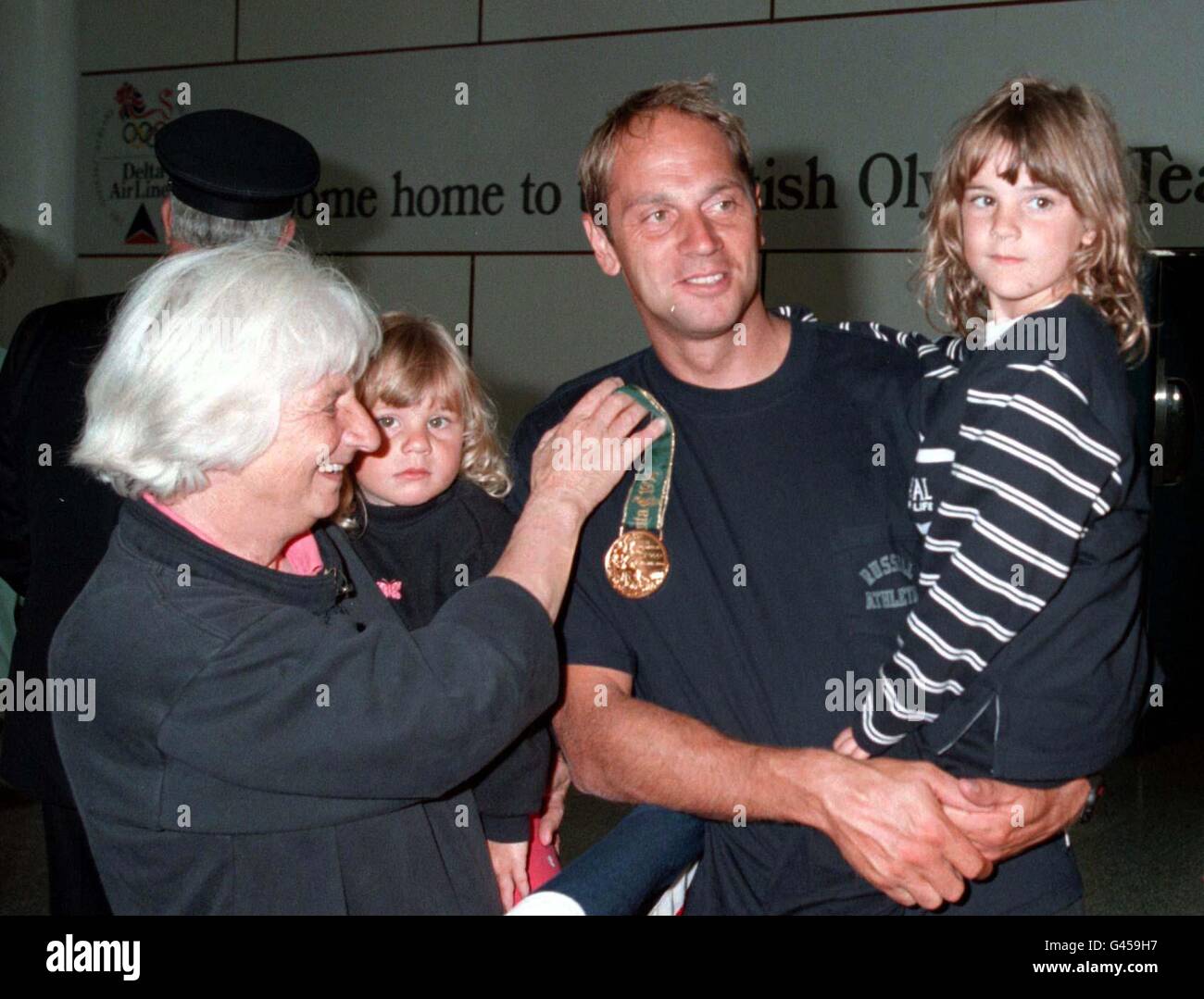 Olympic gold medal rower Steven Redgrave has his medal pinned to him by ...