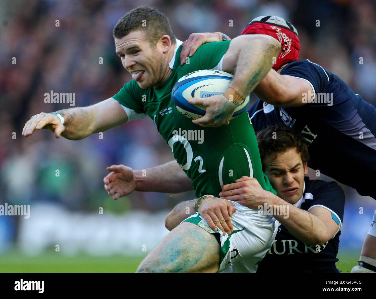 Ireland's Fergus McFadden is tackled by Scotland's Kelly Brown and ...