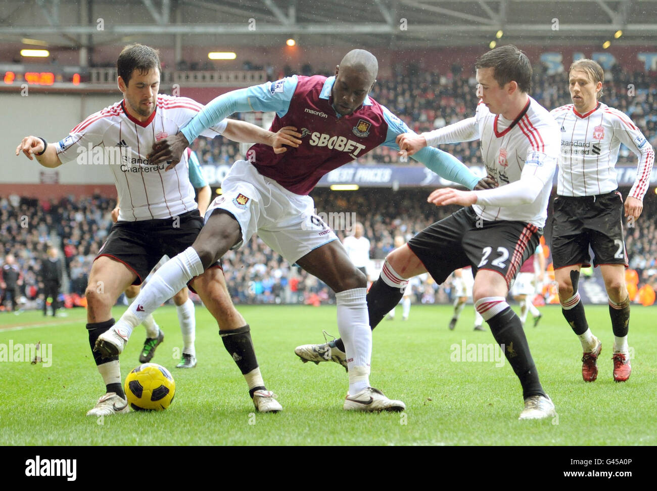 West Ham United's Carlton Cole (centre) holds off the challenge form ...