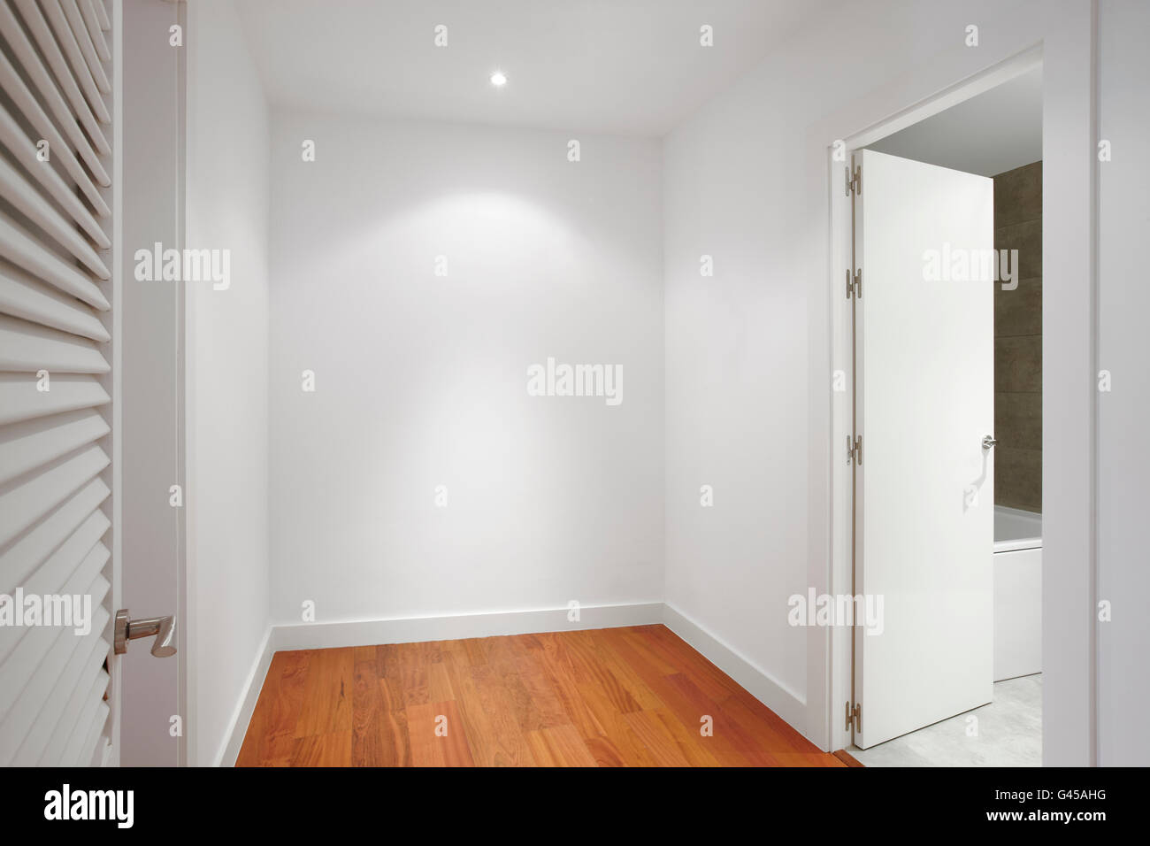 House corridor with white walls and wooden floor. Horizontal format ...