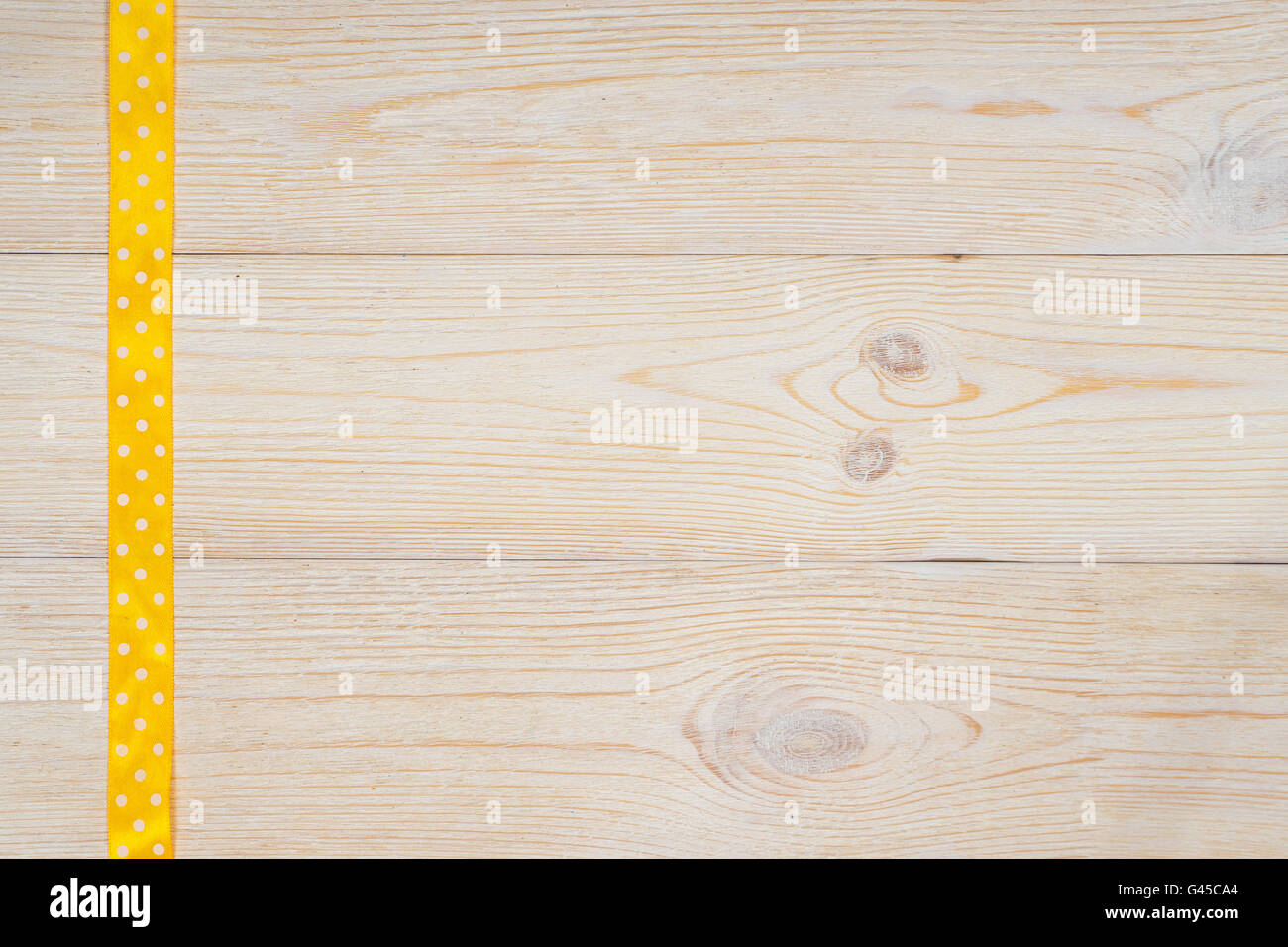 yellow polka dot ribbon on rustic wooden planks Stock Photo - Alamy