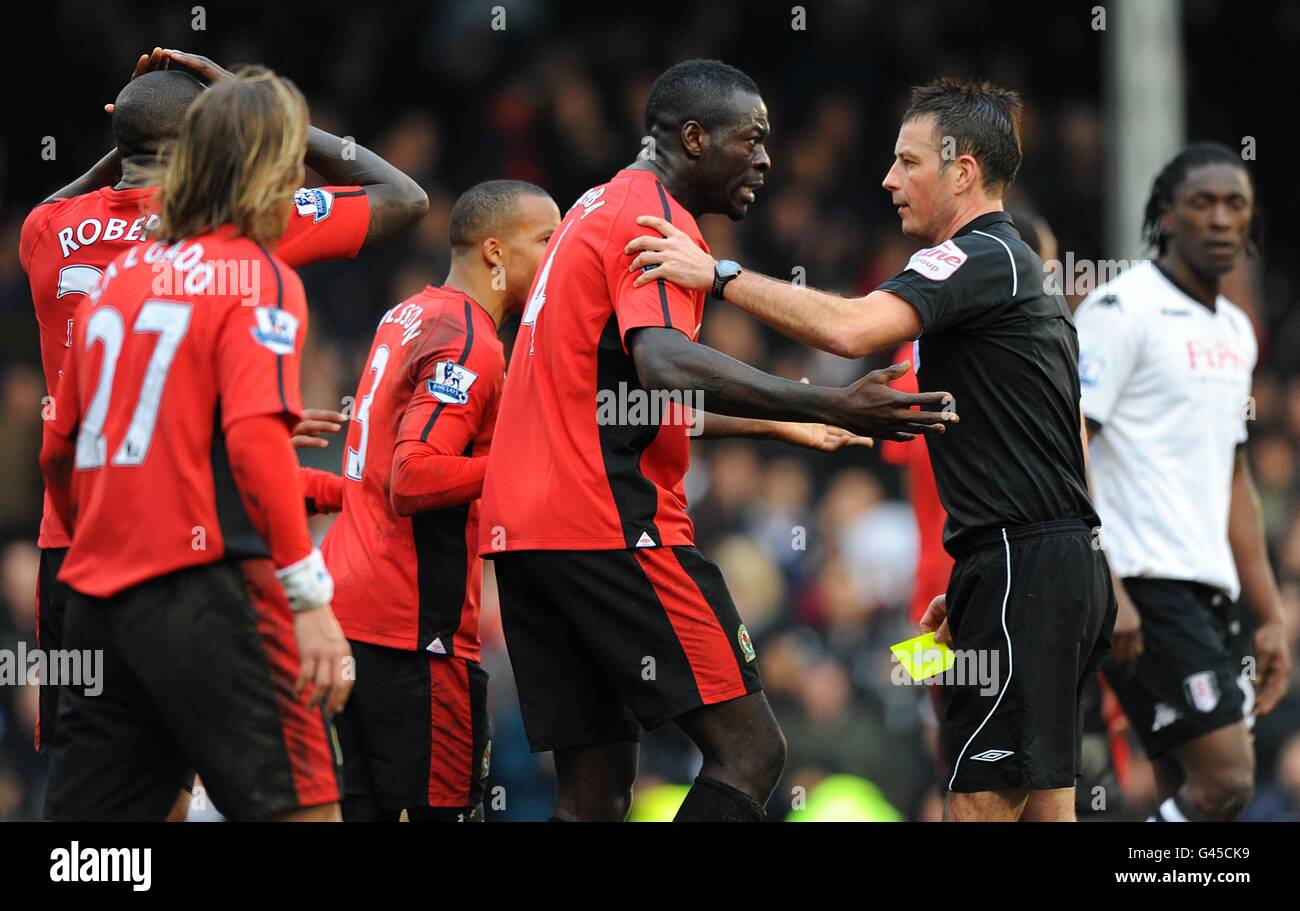 Blackburn Rovers' Christopher Samba (centre) is shown the yellow card ...