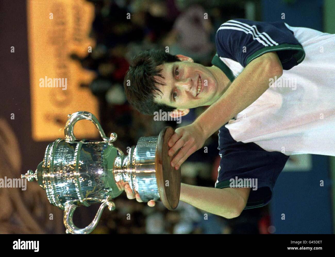 British Number One Tim Henman holds up the trophy after retaining the ...