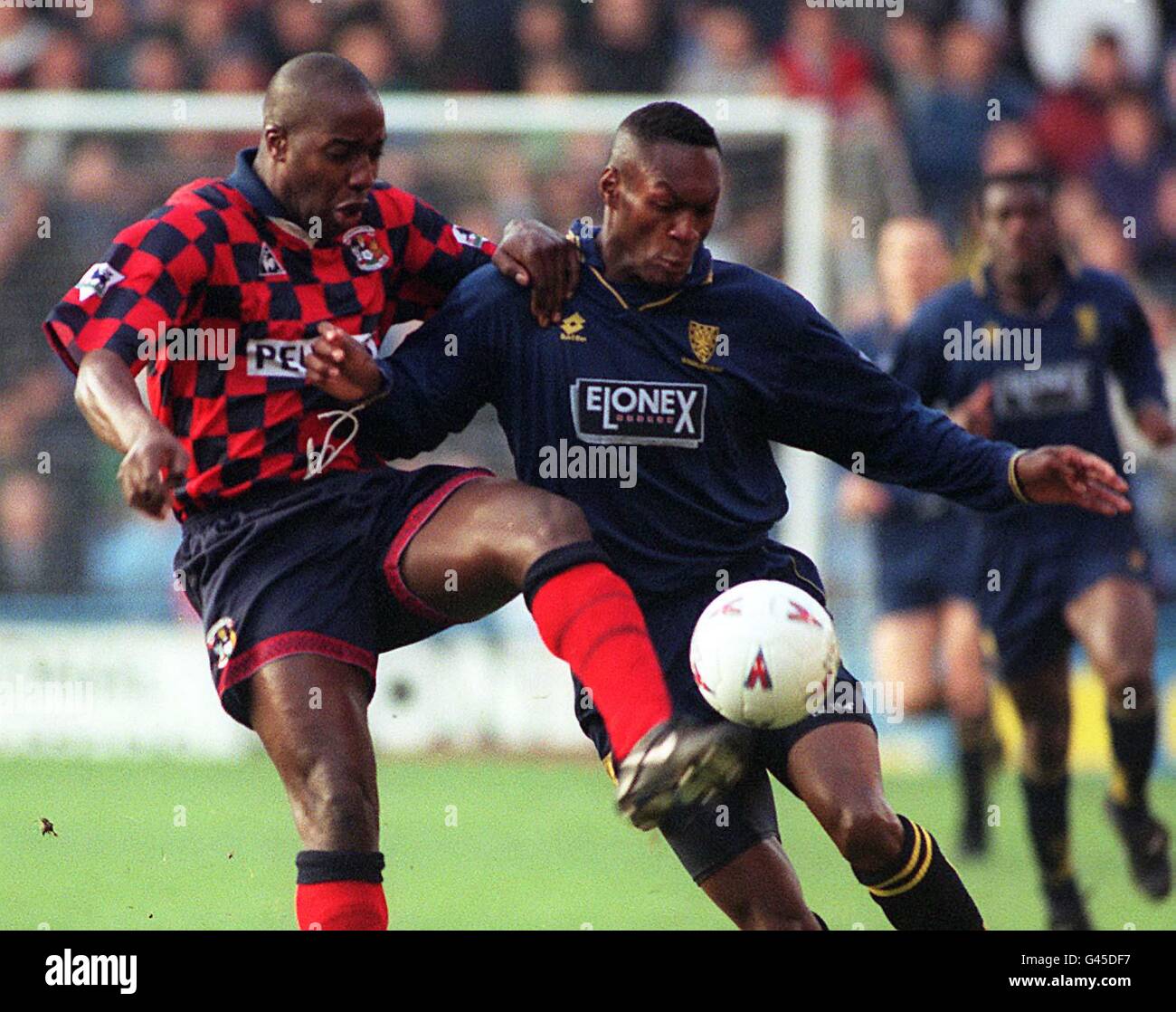 WIimbledon's Marcus Gayle wrestles the ball from Coventry's Paul ...