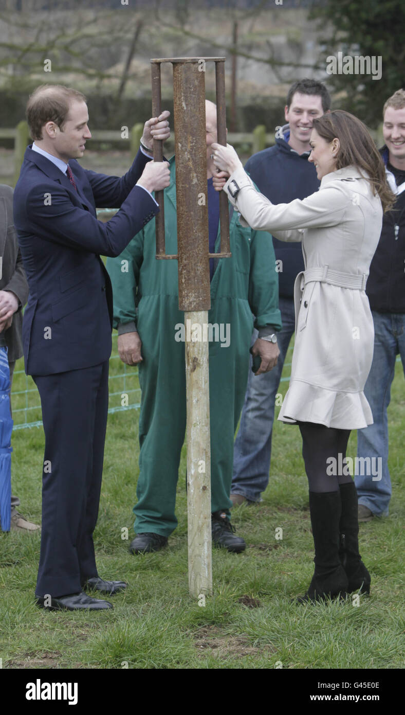 Prince William and Kate Middleton drive a wooden fence post into the ...