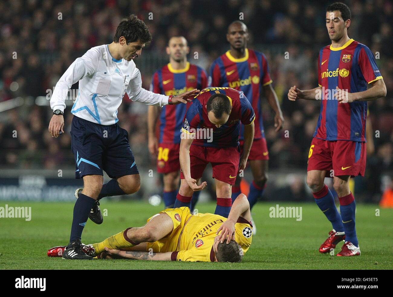 Barcelona's Andres Iniesta (centre) confronts Arsenal's Jack Wilshere ...