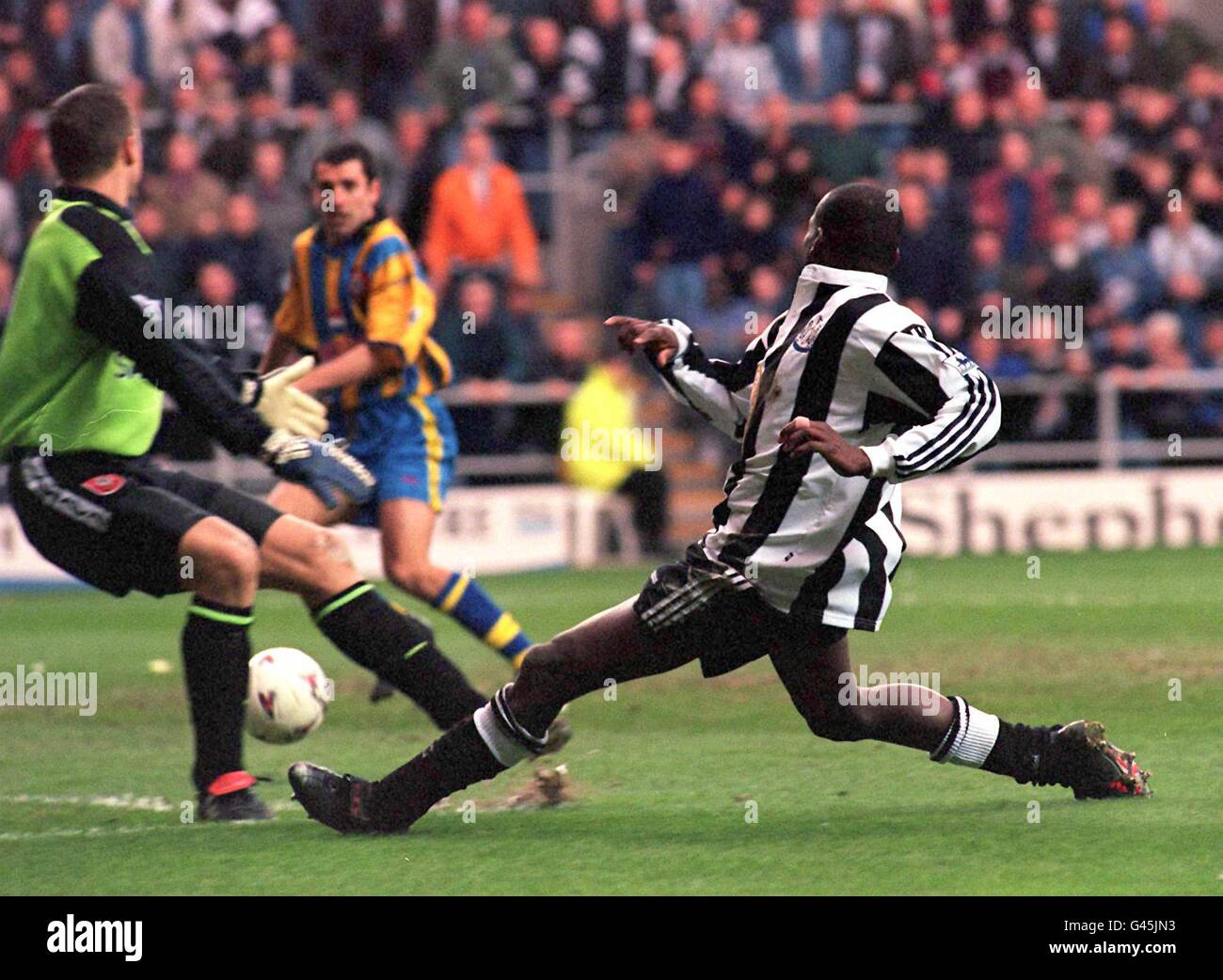 Faustino Asprilla fires his shot through the legs of Southampton ...