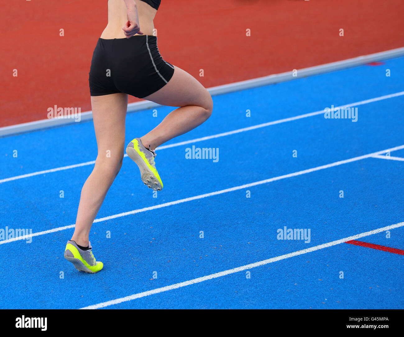young woman running on the athletics track Stock Photo - Alamy