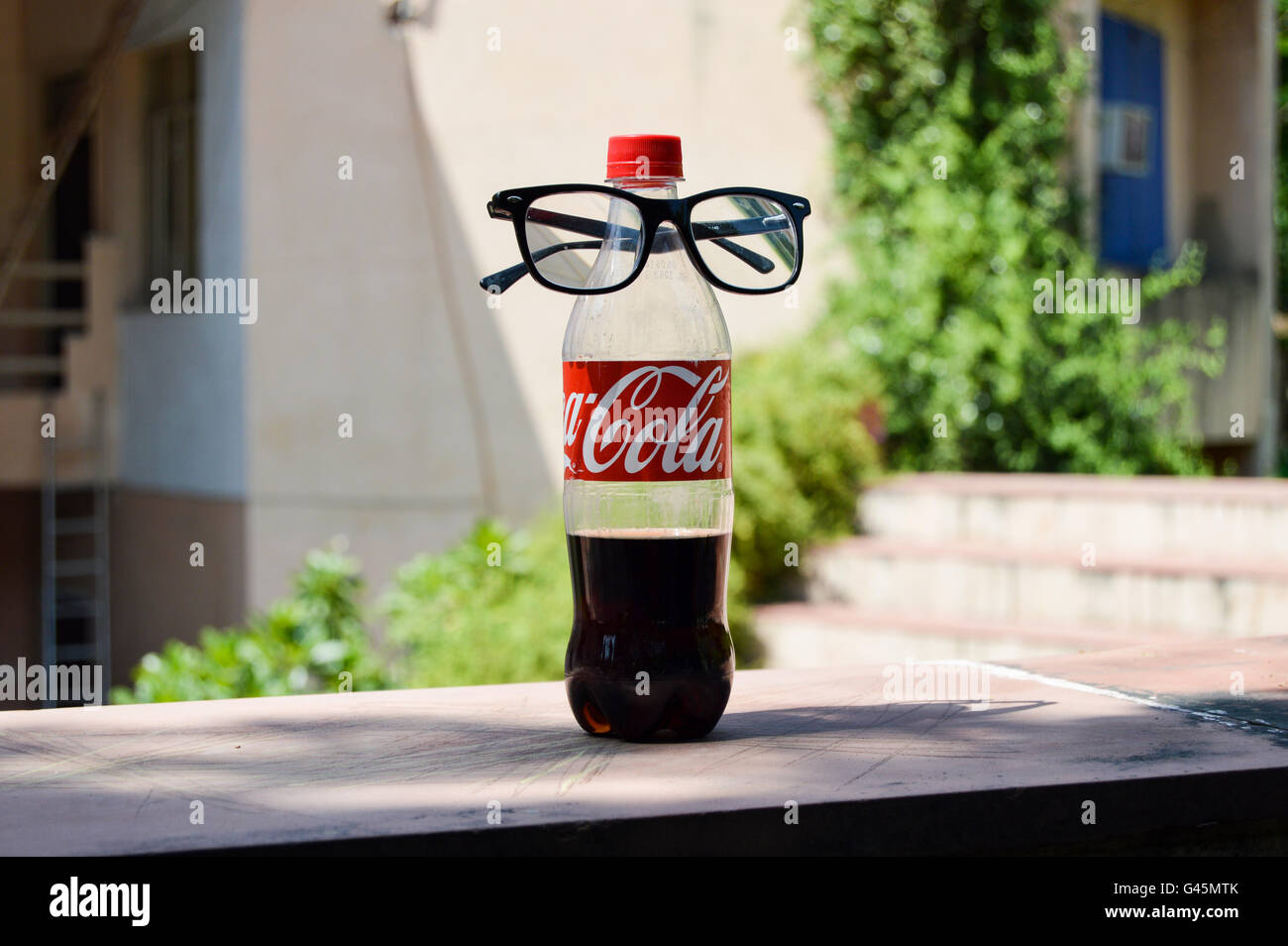 A coca cola bottle with spectacles Stock Photo - Alamy